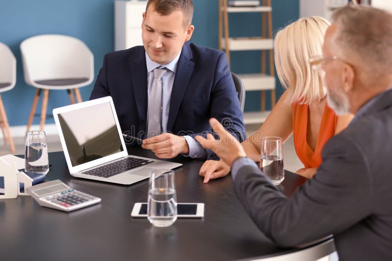 Mature Couple with Estate Agent in Office Stock Image - Image of home ...