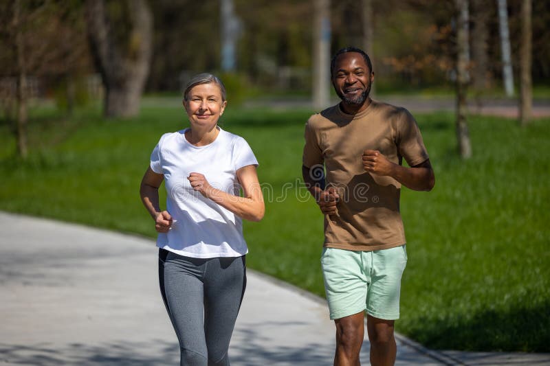 Mature Couple Jogging in the Park Together Stock Photo - Image of male ...