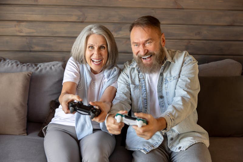 Mature Couple Playing Video Games and Looking Excited Stock Photo ...