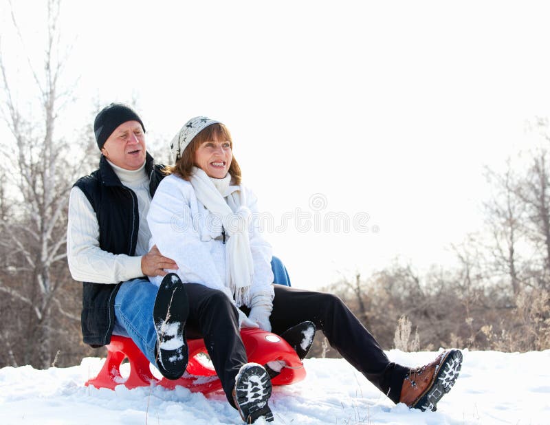 Mature couple sledding stock image. Image of adult, romantic - 26838367