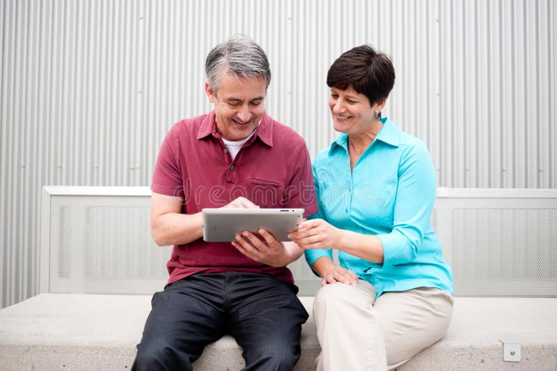 Mature couple with tablet stock photo. Image of married - 33249990