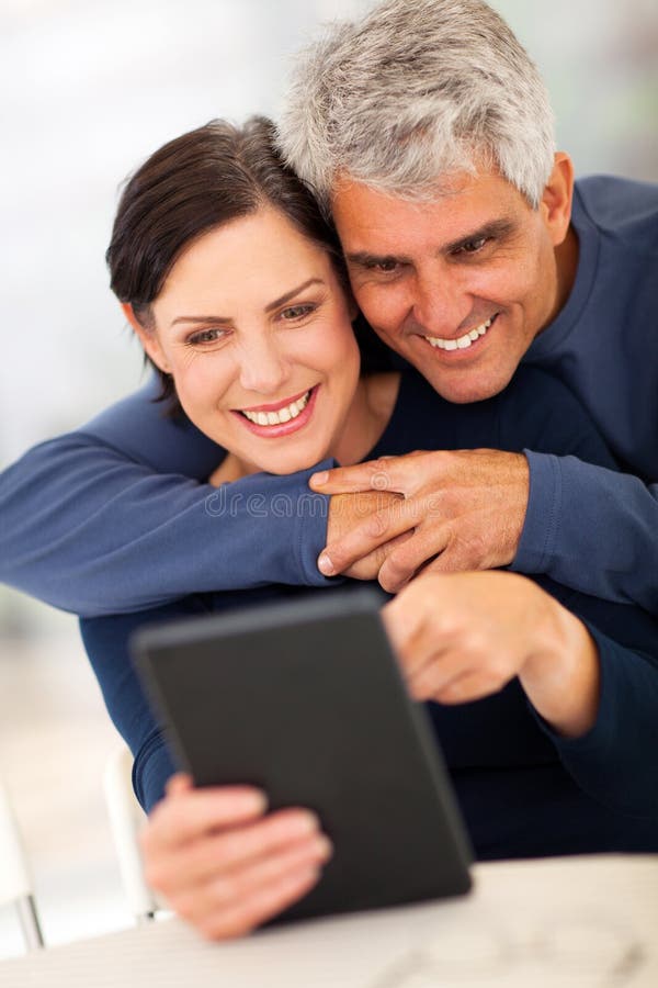 Mature couple tablet stock photo. Image of adult, home - 30696732