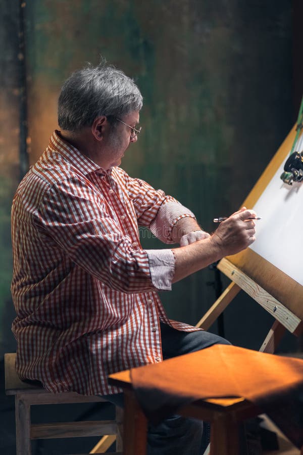 The Mature Creative Engineer Working with Project on Drawing Board ...