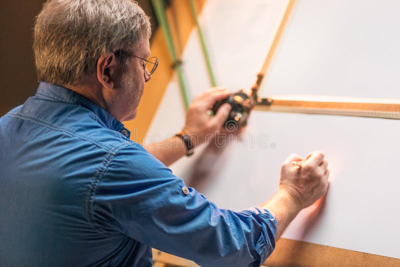 The Mature Creative Engineer Working with Project on Drawing Board ...