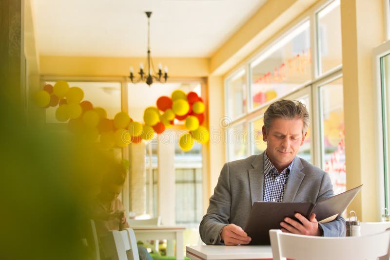 Boy Reading Menu at Restaurant Stock Image - Image of coffee, customer ...