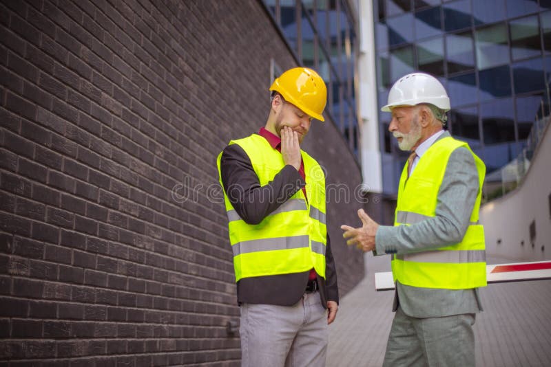 Engineer Discussing the Structure of the Building with Architects ...