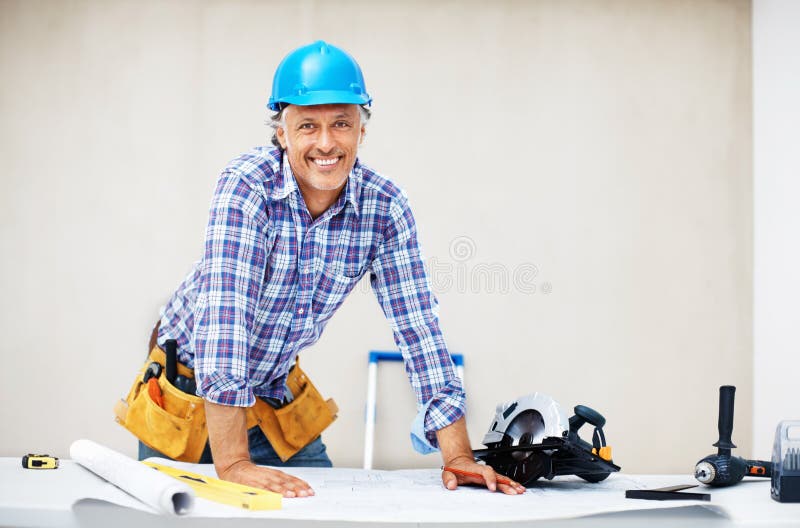 Mature Engineer Reviewing Blueprint. Portrait of Smiling Mature ... Mature Engineer Reviewing Blueprint. Portrait of Smiling Mature ...
