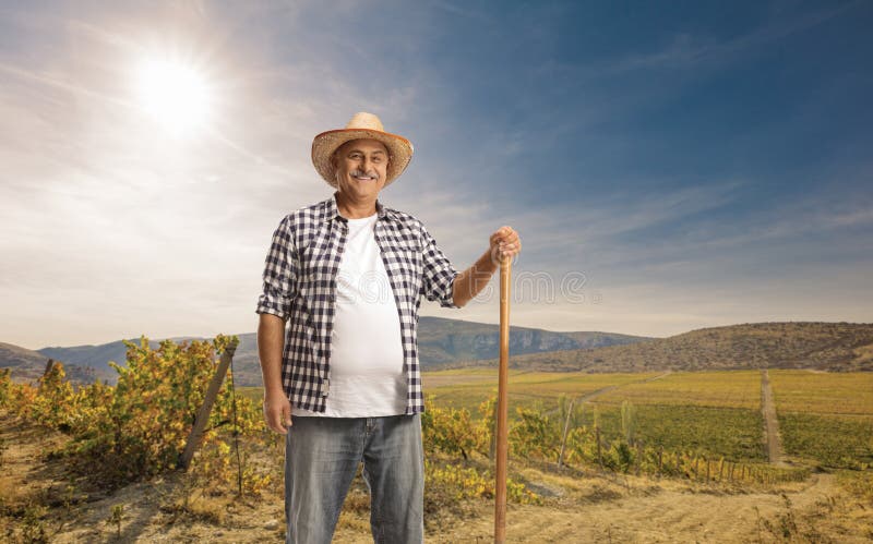 Mature Farmer with a Shovel Standing on a Field Stock Image - Image of ...