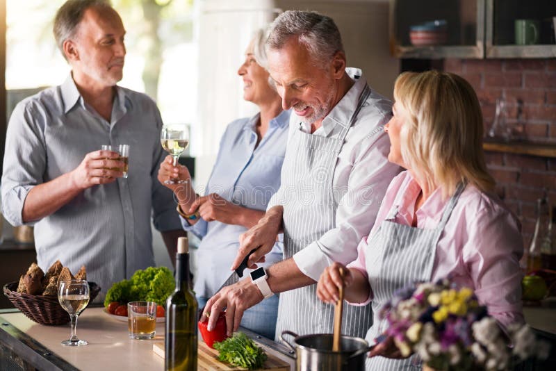 Mature Friends Having Fun while Making Dinner Stock Image - Image of ...