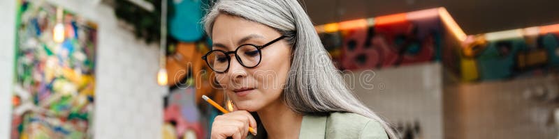 Mature Grey Thinking Woman Working with Planner in Cafe Stock Photo ...