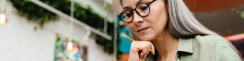 Mature Grey Thinking Woman Working with Planner in Cafe Stock Image ...