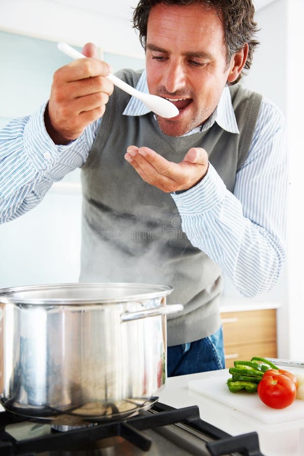 Mature Guy Tasting Food he is Preparing. Portrait of a Mature Guy ...