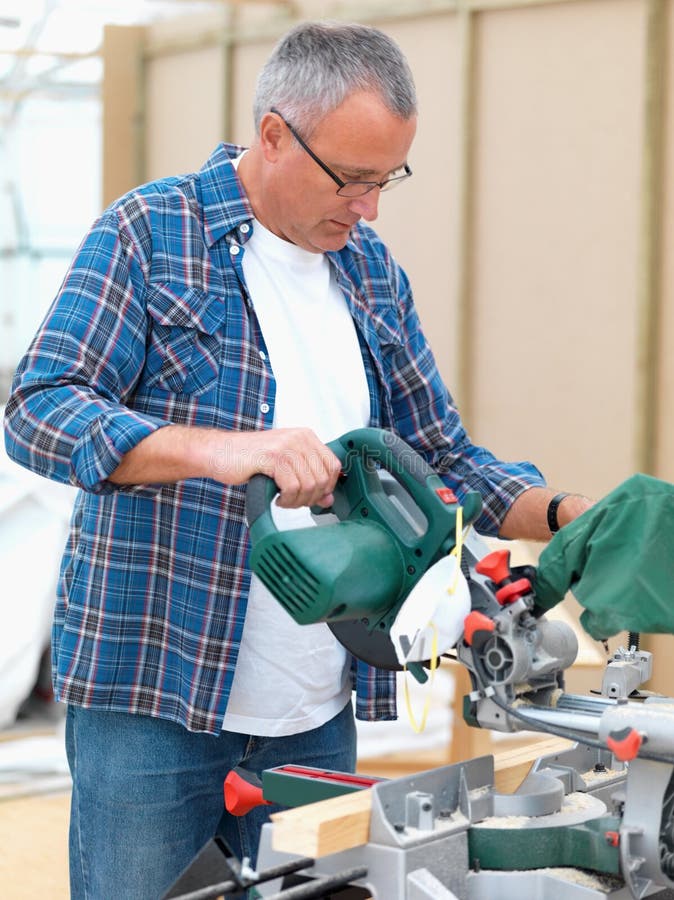 Mature Handy Man Using an Electric Saw Stock Photo - Image of power ...