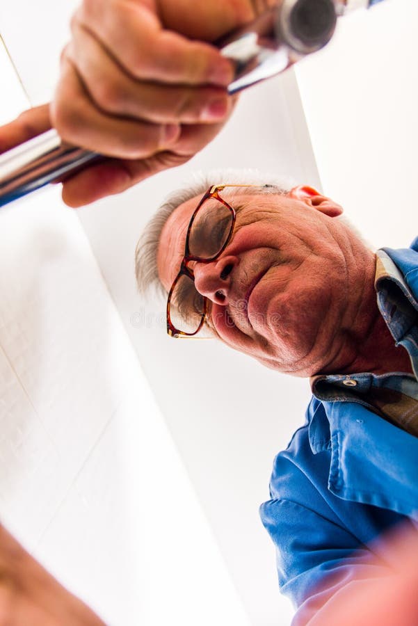 Mature Handyman Install Faucet in Kitchen Stock Photo - Image of ...