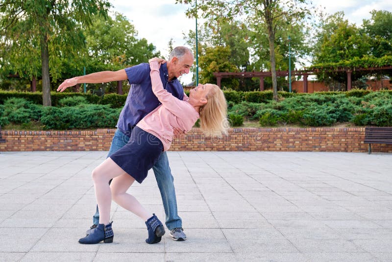 Mature Couple Dancing Tango in a Park at Street. Stock Photo - Image of ...