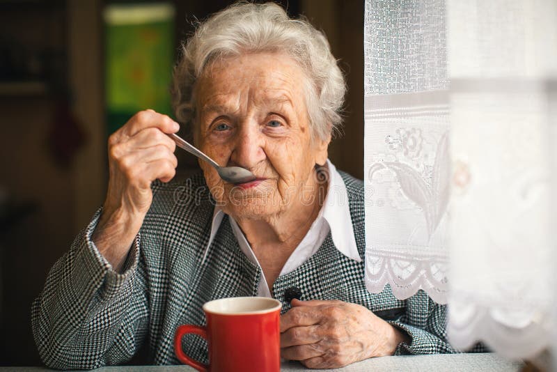 Mature Happy Woman Drinking Tea in the Kitchen. Stock Photo - Image of ...