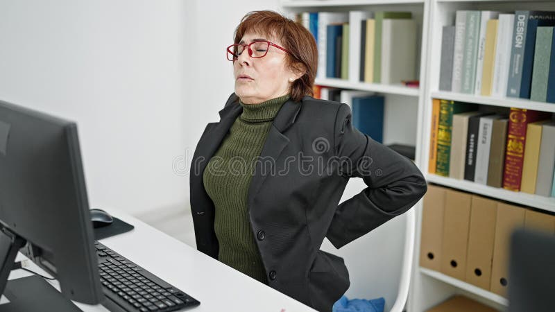 Mature Hispanic Woman University Teacher Using Computer with Back Ache ...