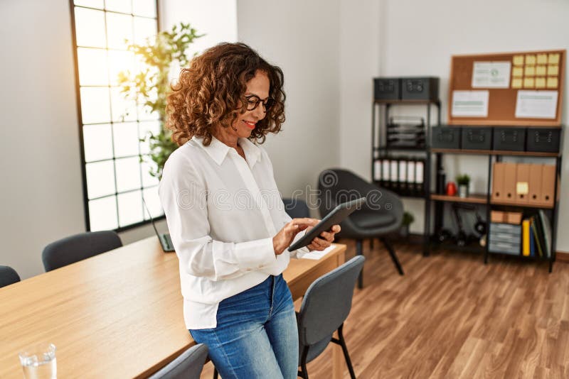 Mature Hispanic Woman Working at the Office Stock Photo - Image of ...