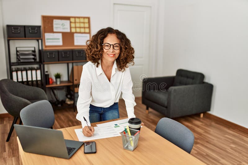 Mature Hispanic Woman Working at the Office Stock Photo - Image of ...