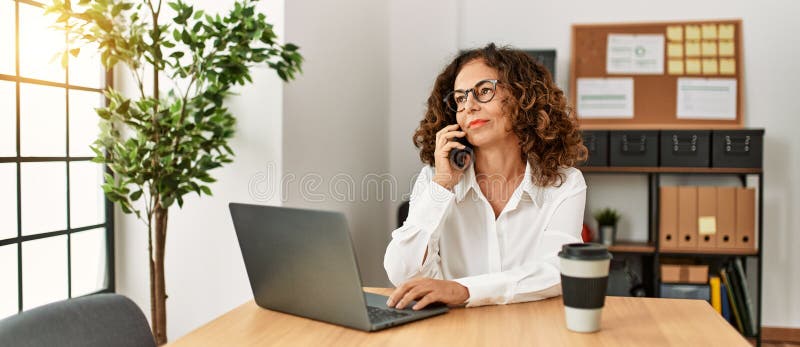 Mature Hispanic Woman Working Speaking on the Phone at the Office Stock ...