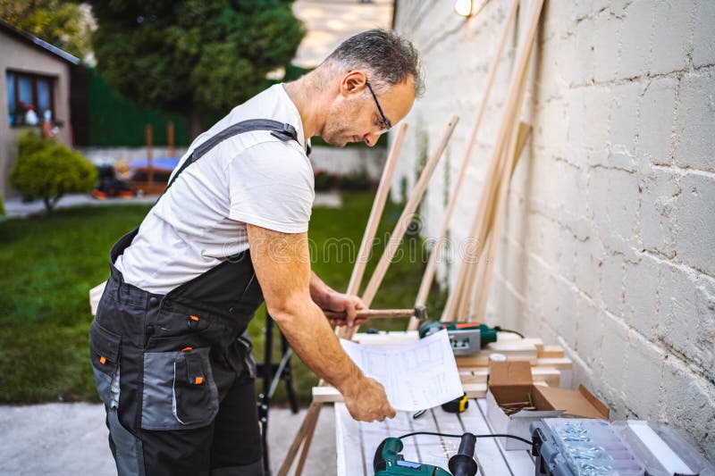 Mature Male Carpenter Working with Wooden Plank Outdoors Stock Photo ...