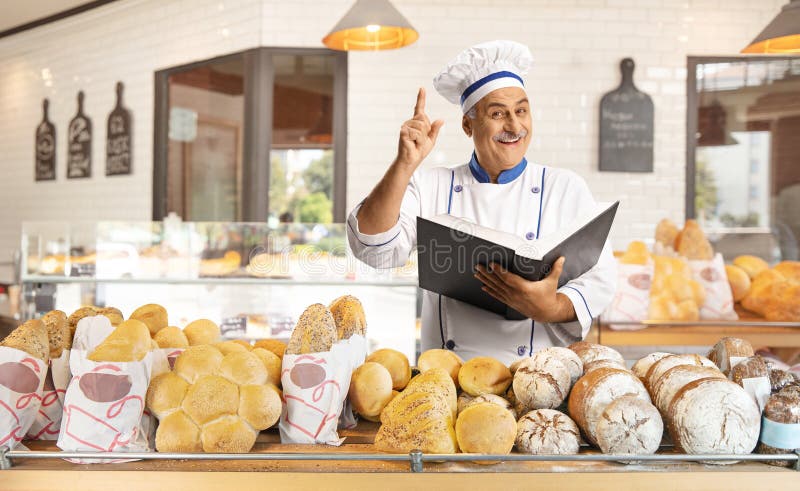 Mature Male Chef Holding a Cook Book in a Bakery Stock Image - Image of ...