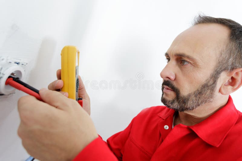 Mature Male Electrician Testing Socket with Multimeter Stock Photo ...