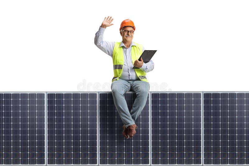 Male Engineer Posing with a Solar Panel and Workers Carrying Panels in ...