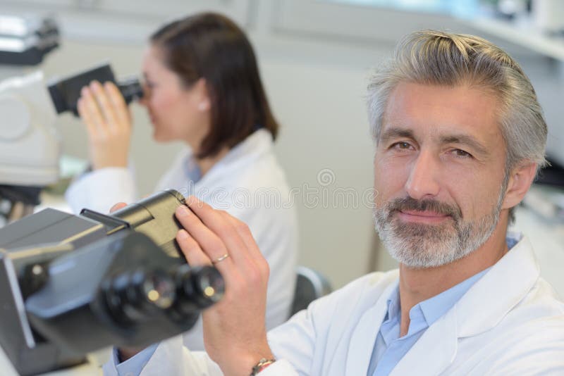 Mature Male Researcher Using Microscope in Medical Laboratory Stock ...