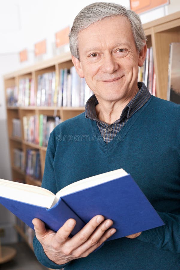 Mature Male Student Reading Book in Library Stock Image - Image of ...