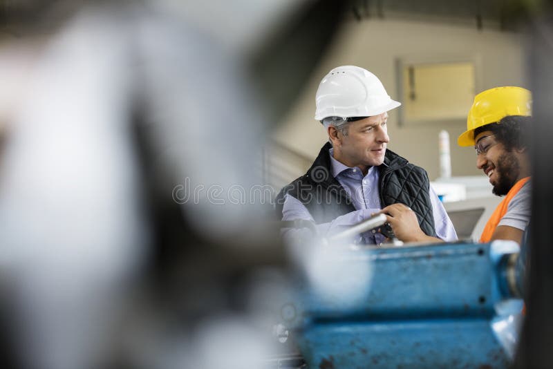Mature Male Supervisor Talking with Worker in Metal Industry Stock ...