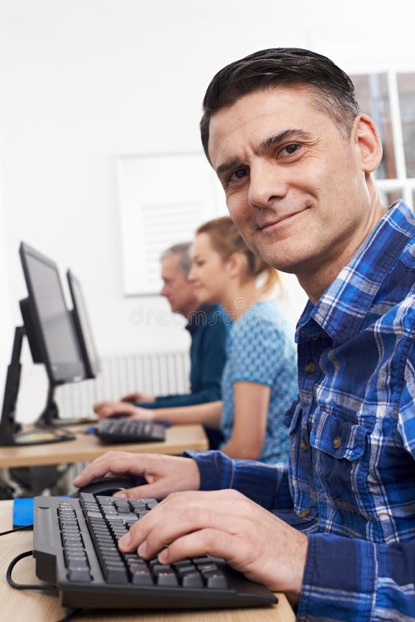 Tutor Helping Mature Man in Computer Class Stock Photo - Image of ...