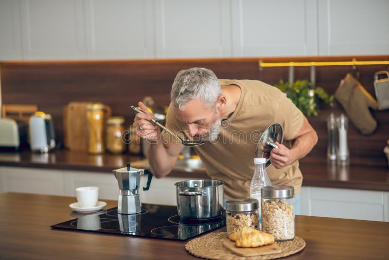 Mature Man in Beige Tshirt Cooking in the Kitchen Stock Image - Image ...