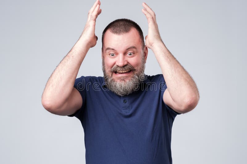 Mature Man in Blue T-shirt Expressive Gesticulating with Hands, Trying ... Mature Man in Blue T-shirt Expressive Gesticulating with Hands, Trying ...