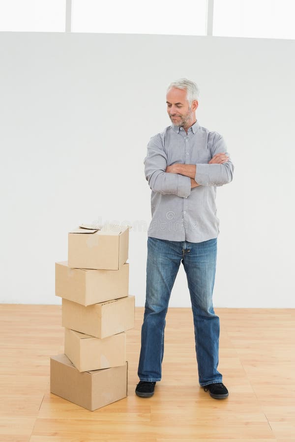 Mature Man with Boxes in a New House Stock Photo - Image of indoors ...