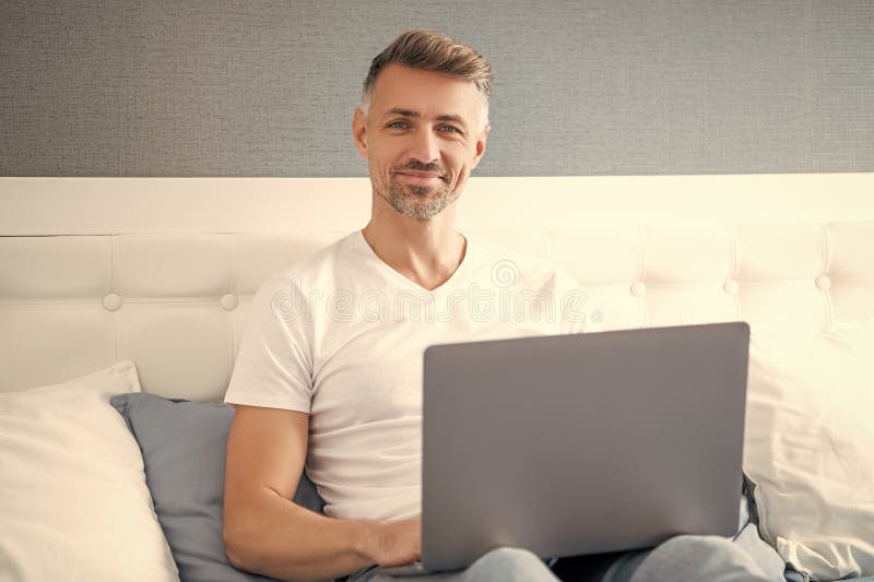 Mature Man Buy Online on Laptop in Bed Stock Image - Image of browsing ...