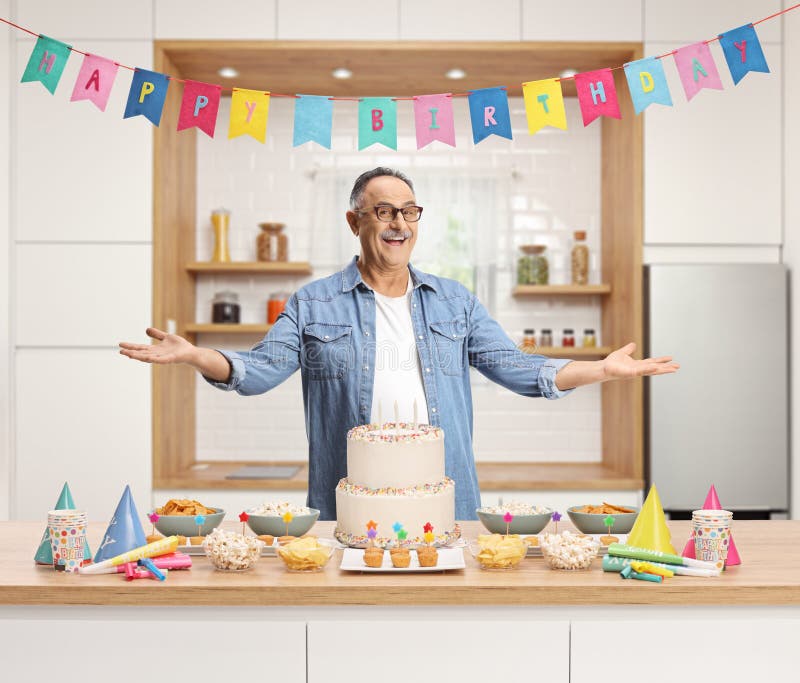 Mature Man with a Cake Standing Inside a Decorated Kitchen and ...