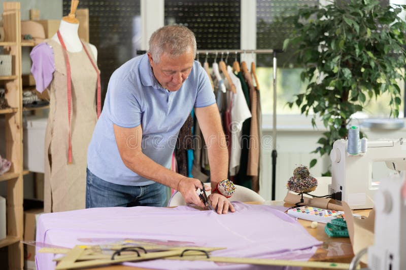 Mature man cutting fabric stock photo. Image of hispanic - 383696930