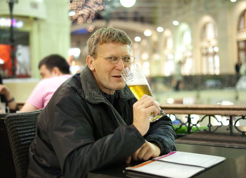 Mature man drinks beer stock image. Image of looking - 21577501