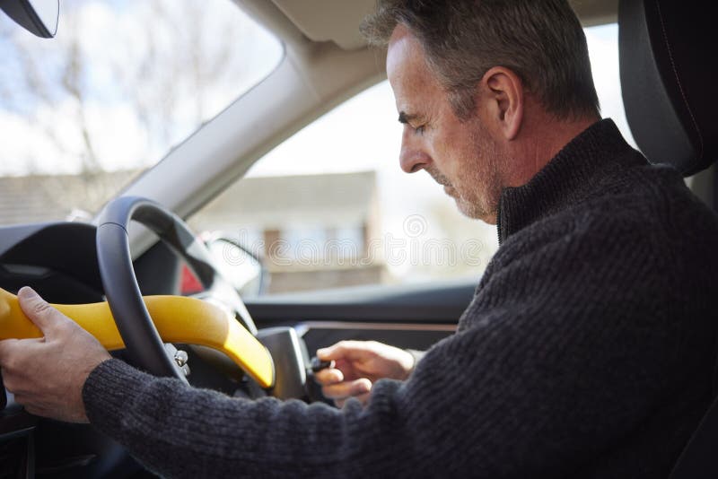 Mature Man Fitting Manual Steering Wheel Lock in Car Stock Image ...