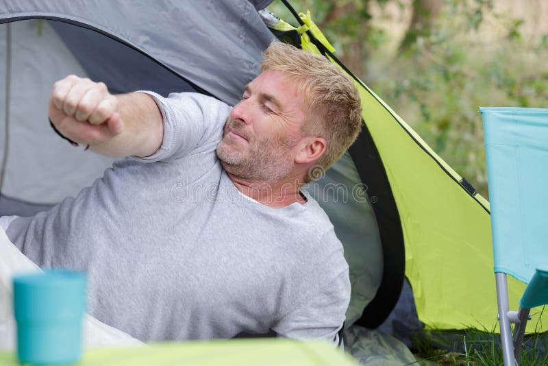 Mature Man Getting Up Form Tent Stock Image - Image of holding, camera ...