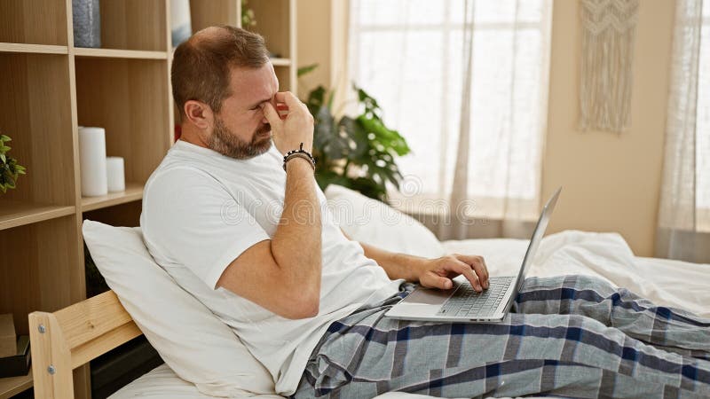 Mature Man with Grey Hair Experiences a Headache while Using a Laptop ...