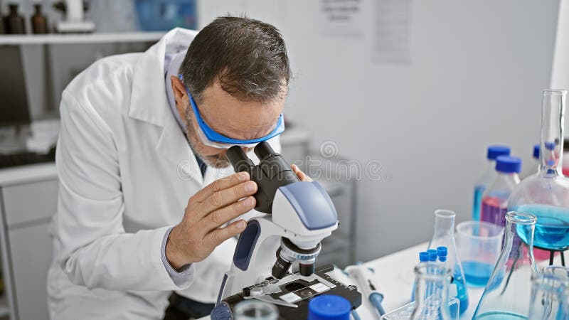 Mature Man with Grey Hair- a Scientist Captured at Work in a Laboratory ...