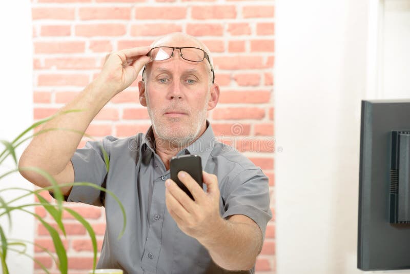 Mature Man Having Trouble Seeing Phone Screen Stock Photo - Image of ...