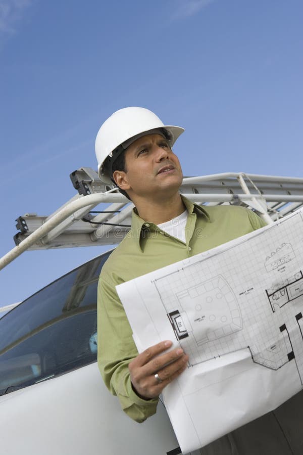 Mature Man in Hardhat with Blueprint at House Construction Site Stock ...