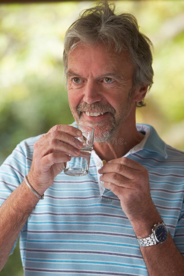 Mature Man at Home Taking Tablet Stock Image - Image of looking, beard ...