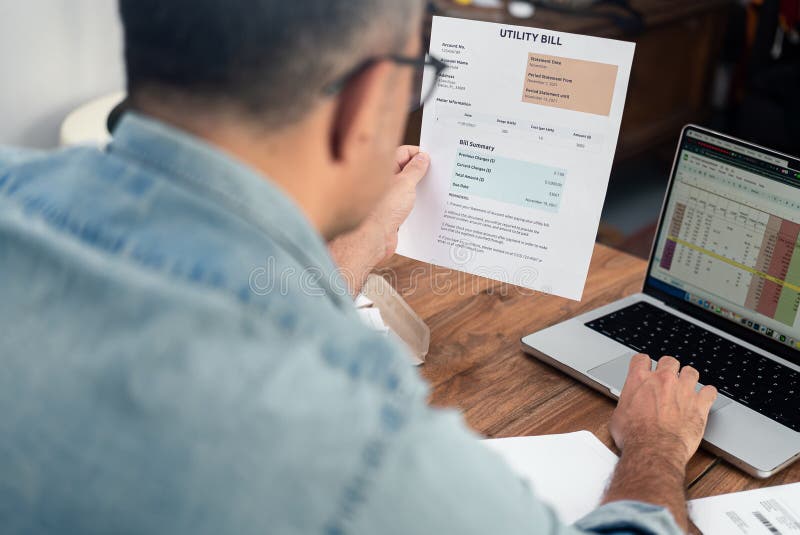 Mature Man Inputs Utility Bill Data in Digital Spreadsheet Working on ...