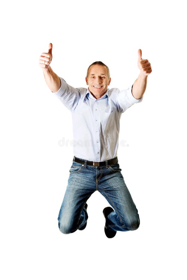 Mature Man Jumping with Thumbs Up Stock Photo - Image of shirt ...