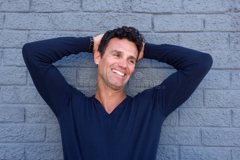 Mature Man Laughing with Hands Behind Head Stock Photo - Image of blue ...