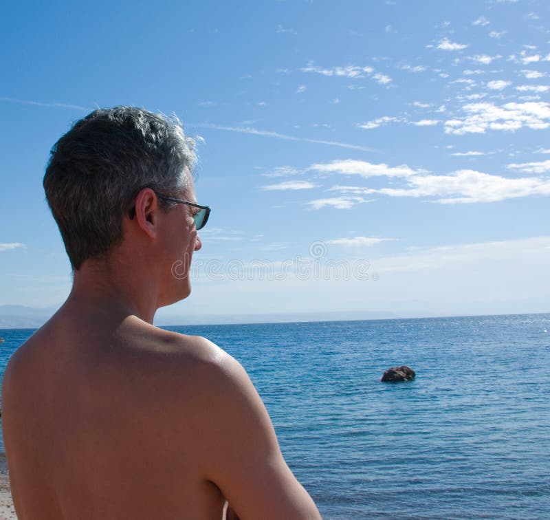 Mature man looking at sea stock image. Image of shades - 7744571